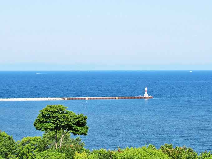 The Petoskey Breakwater Lighthouse stands sentinel over Little Traverse Bay, like a maritime exclamation point to nature's scenic sentence.