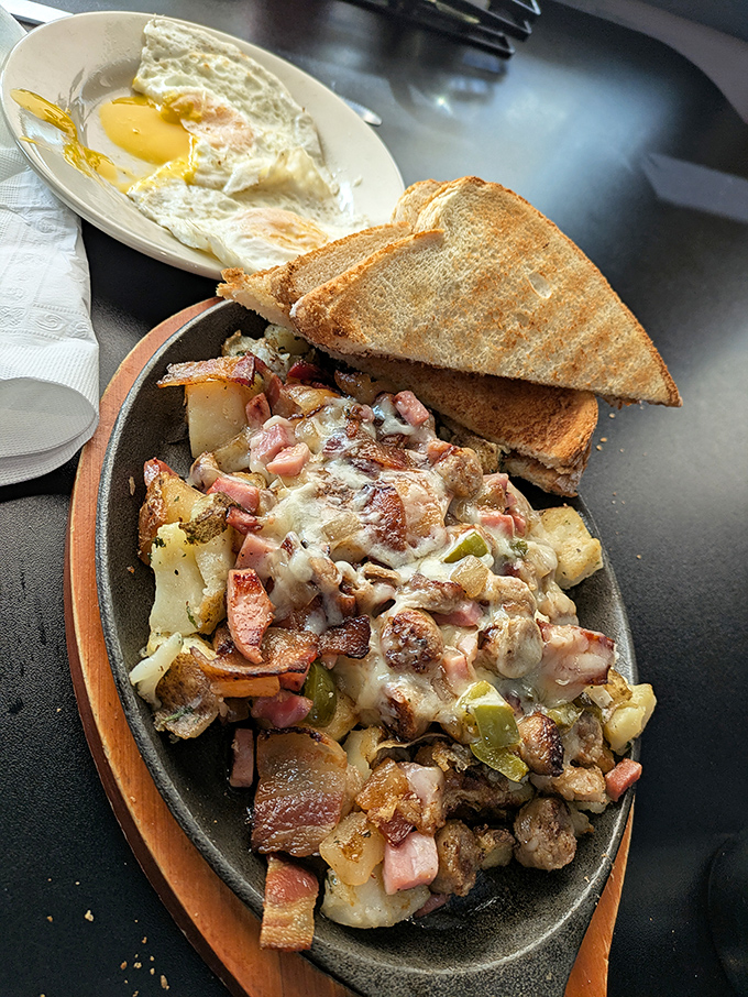 The legendary "Pig Pile" &ndash; a mountain of breakfast potatoes, ham, bacon, and melted cheese that might require a nap afterward. Worth every calorie!