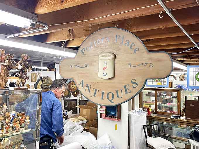 A wooden sign marks the entrance to the antiques section, where browsers lose themselves in memories and discoveries.
