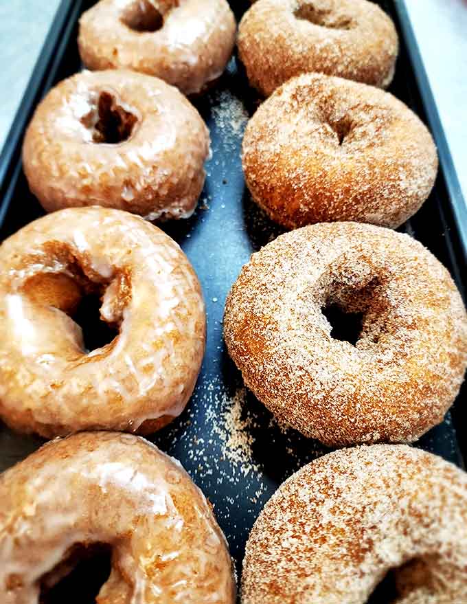 Pumpkin donuts: Fall's greatest gift – these cinnamon-sugar coated treasures and their glazed companions deliver autumn in every perfect bite.