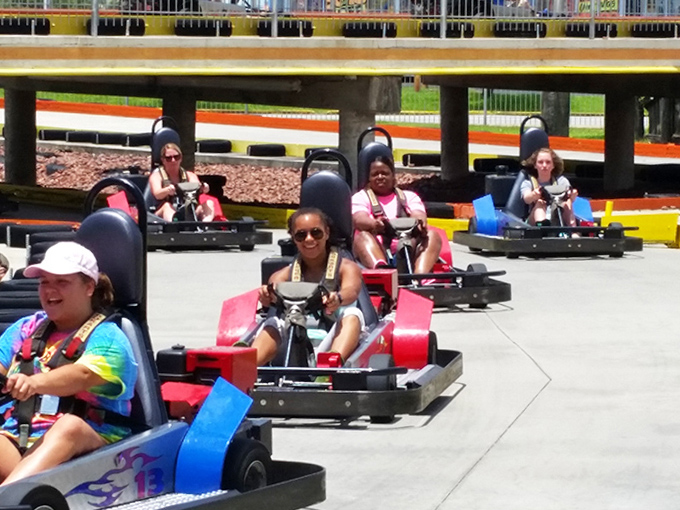 Competitors line up like colorful beads on a necklace, each driver plotting their path to victory.