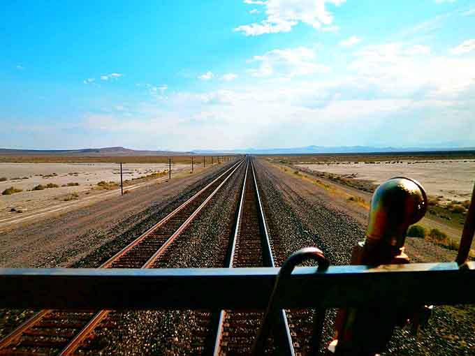 Railroad tracks stretching to infinity remind you that the journey matters just as much as wherever you're headed.