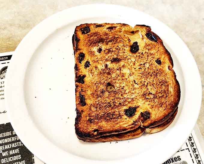 Raisin bread toast that's achieved the golden-brown perfection we all aim for but rarely achieve at home.