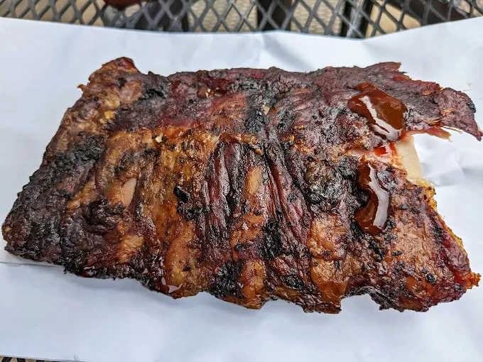 Behold the bark! These ribs showcase that perfect pink smoke ring that makes barbecue aficionados weak in the knees and ready to propose marriage.