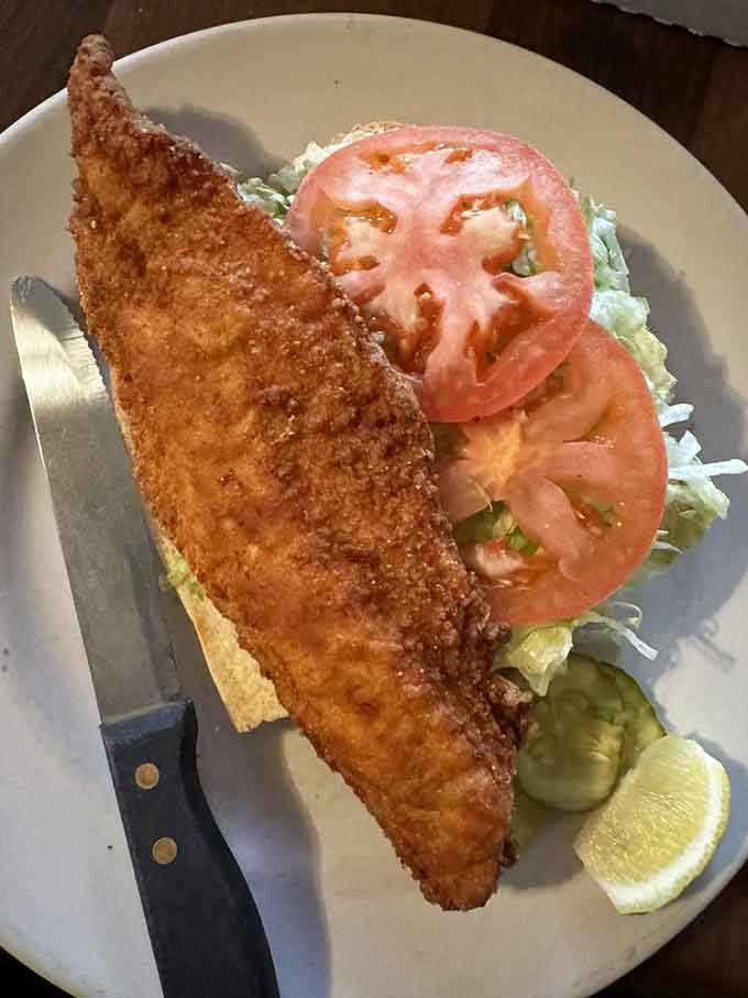 This walleye sandwich is so generously portioned, you might need a strategy session before your first bite of golden perfection.