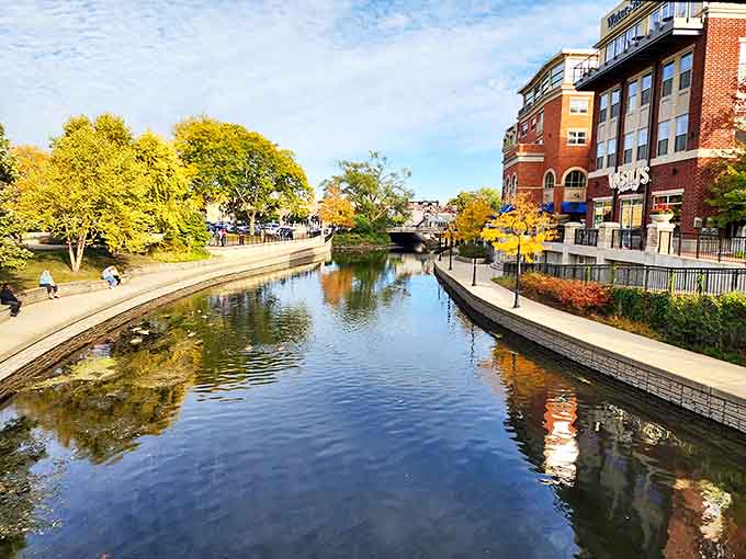 The DuPage River reflects autumn's golden touch along Naperville's Riverwalk, where couples stroll and memories are made.