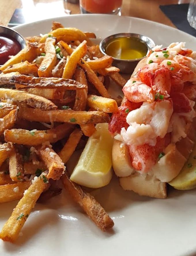 Those hand-cut fries aren't just a side dish, they're the supporting cast that makes the lobster roll's starring performance even more memorable.