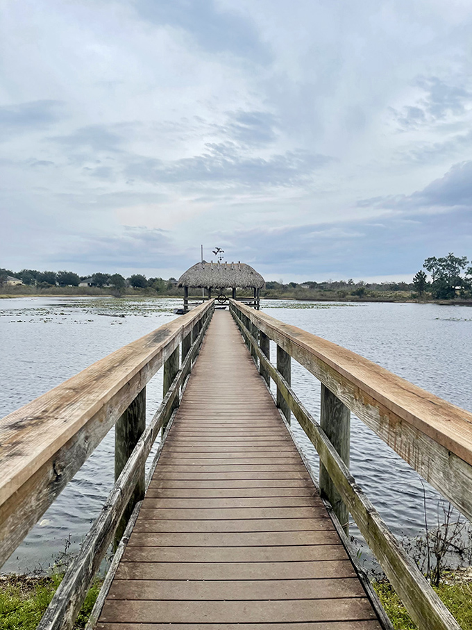 A wooden boardwalk stretches across tranquil waters to a thatched-roof gazebo &ndash; a moment of serenity amid the adventure.