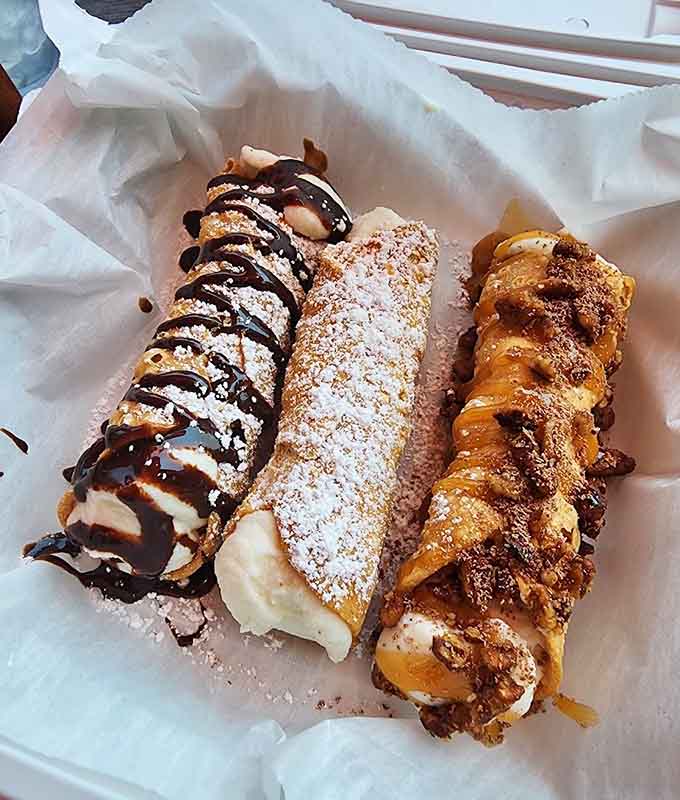 Three cannoli variations prove that dessert decisions can be delightfully difficult, each shell packed with sweet ricotta dreams and chocolate drizzles.