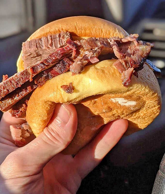 Thick-sliced perfection between bread &ndash; the pink smoke ring and charred edges tell the story of hours in the smoker.