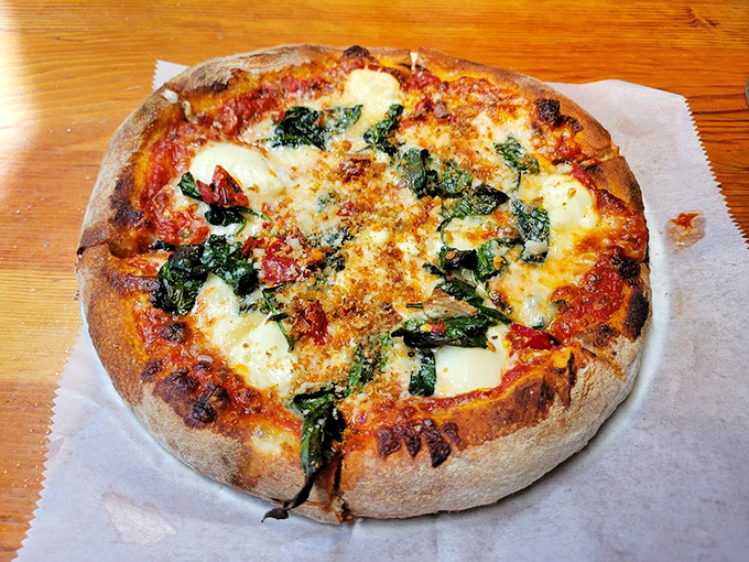 The Spicy Florentine pizza balances earthy spinach with vibrant tomato sauce and pools of melted cheese &ndash; proof that simplicity, done right, is revolutionary.