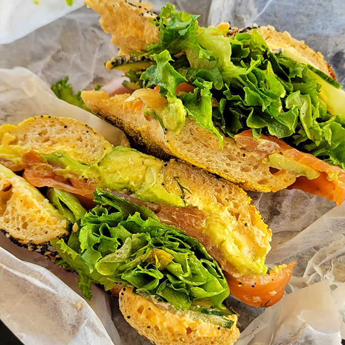 The Spicy Salmon sandwich balances rich fish with crisp greens and creamy avocado, creating a breakfast worth setting your alarm for.