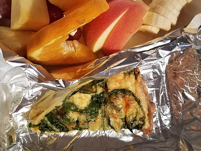 A slice of spinach feta quiche accompanied by fresh fruit&mdash;breakfast of champions or lunch of leisure? Why not both?