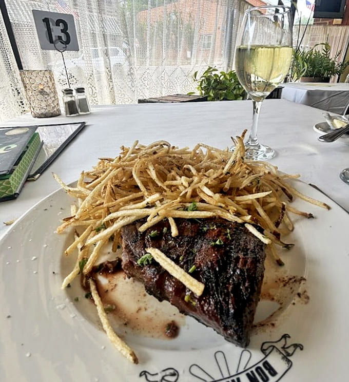 Table 13 might be your lucky number when it brings you this perfect pairing: a juicy steak beneath crispy frites with a glass of wine.