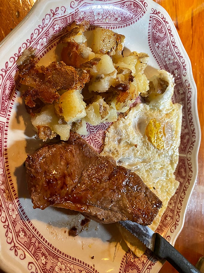 When breakfast gets serious: perfectly cooked steak alongside golden eggs and home fries that could convert a breakfast skeptic.
