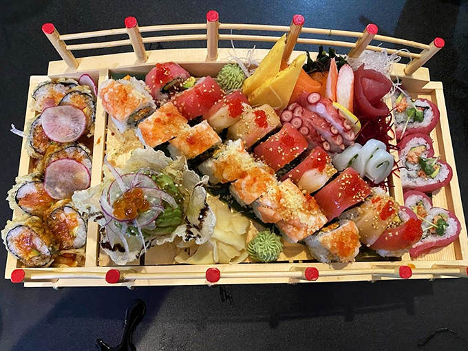 A wooden boat arrives bearing colorful treasures &ndash; fresh sushi arranged like jewels, each piece promising a different flavor adventure.