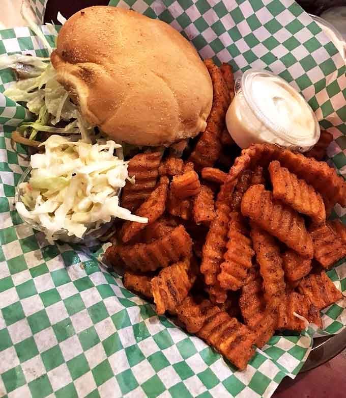 Sweet potato fries so perfectly seasoned they make regular potatoes question their life choices, accompanied by fresh coleslaw for that perfect contrast.