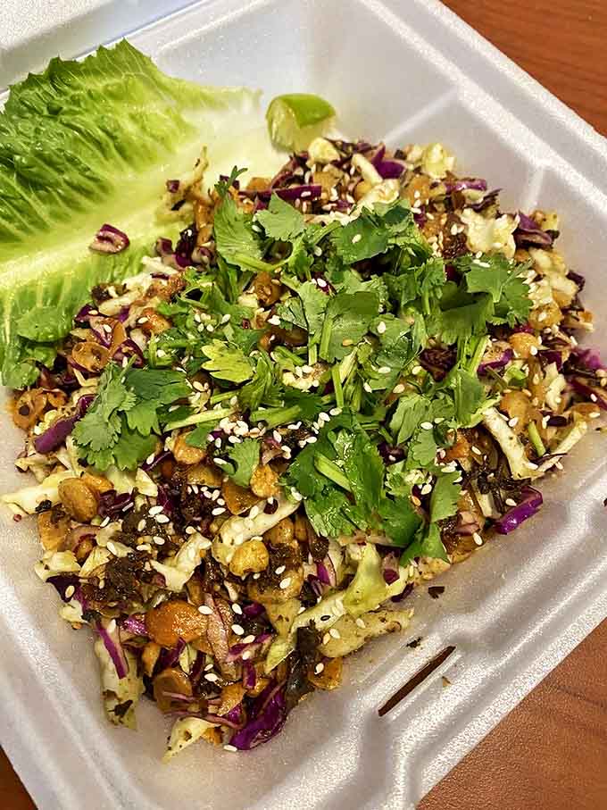 The legendary tea leaf salad&mdash;a textural wonderland where fermented tea leaves meet crunchy nuts, seeds, and fresh herbs in perfect harmony.