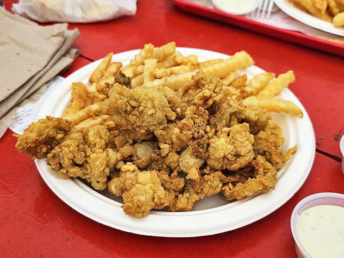 Fried clams piled high like edible treasure, each piece a crunchy testament to Maine's seafood superiority and frying expertise.