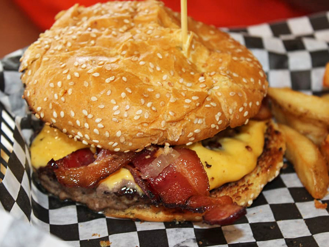 A sesame seed bun glistening with burger perfection, because sometimes classic presentation is all you need to be spectacular.