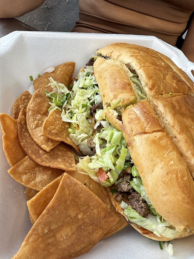 A sandwich that means business &ndash; pillowy bread embracing seasoned steak, fresh veggies, and those addictive homemade chips.