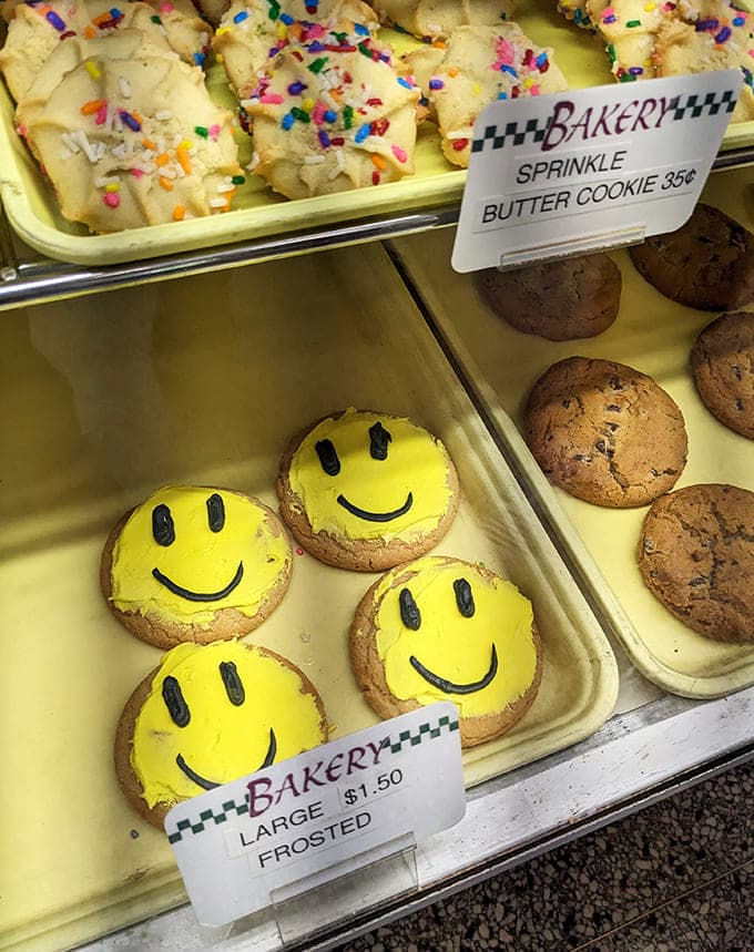 Happiness is a yellow smiley face cookie staring back at you, while sprinkle butter cookies wait patiently nearby, promising simple, buttery perfection with every bite.
