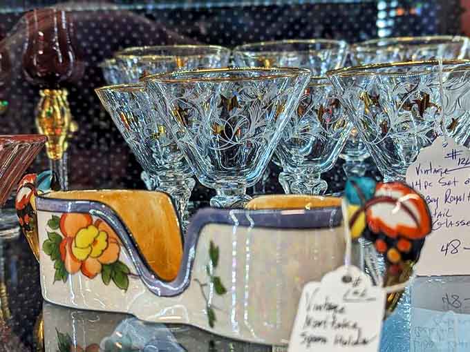 Crystal glasses catching light like frozen champagne bubbles, elegant reminders of when every dinner party required proper stemware and matching napkins.