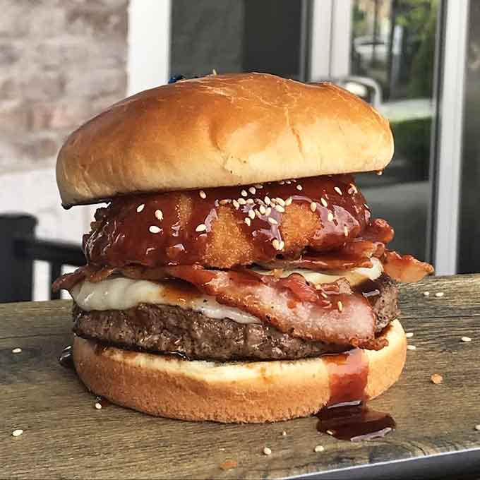 This burger stacks up beautifully with bacon, cheese, and all the fixings your heart desires.