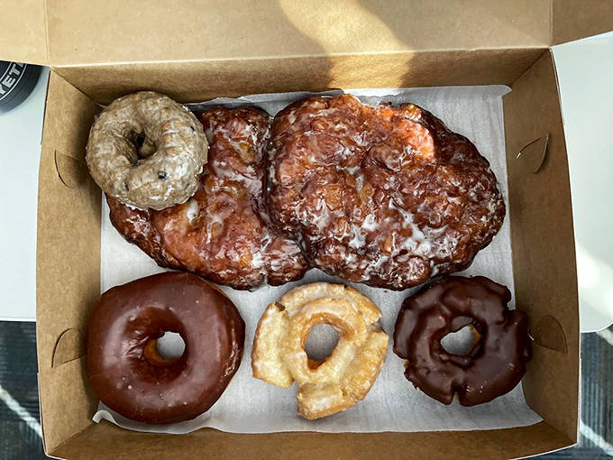 A box of mixed treasures awaits its lucky recipient&mdash;the perfect balance of glazed classics, chocolate-dipped delights, and that show-stopping fritter.