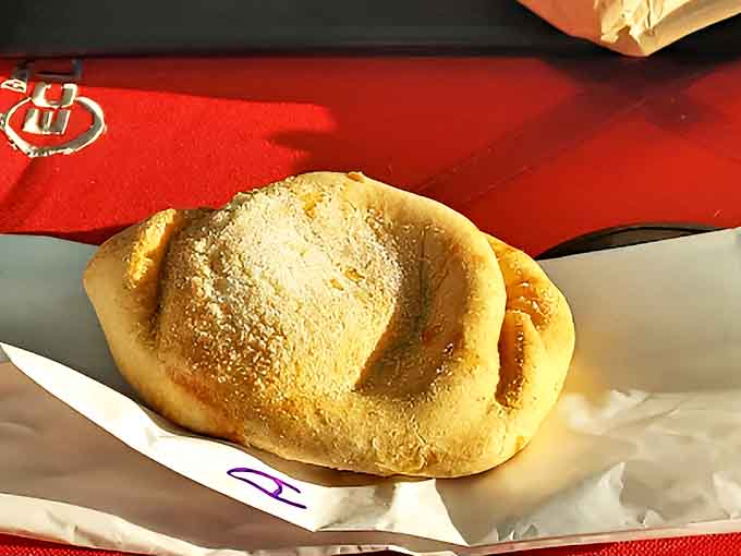 Sweet endings: An apple pie pasty dusted with sugar, where dessert meets convenience in a hand-held package of fruity delight.