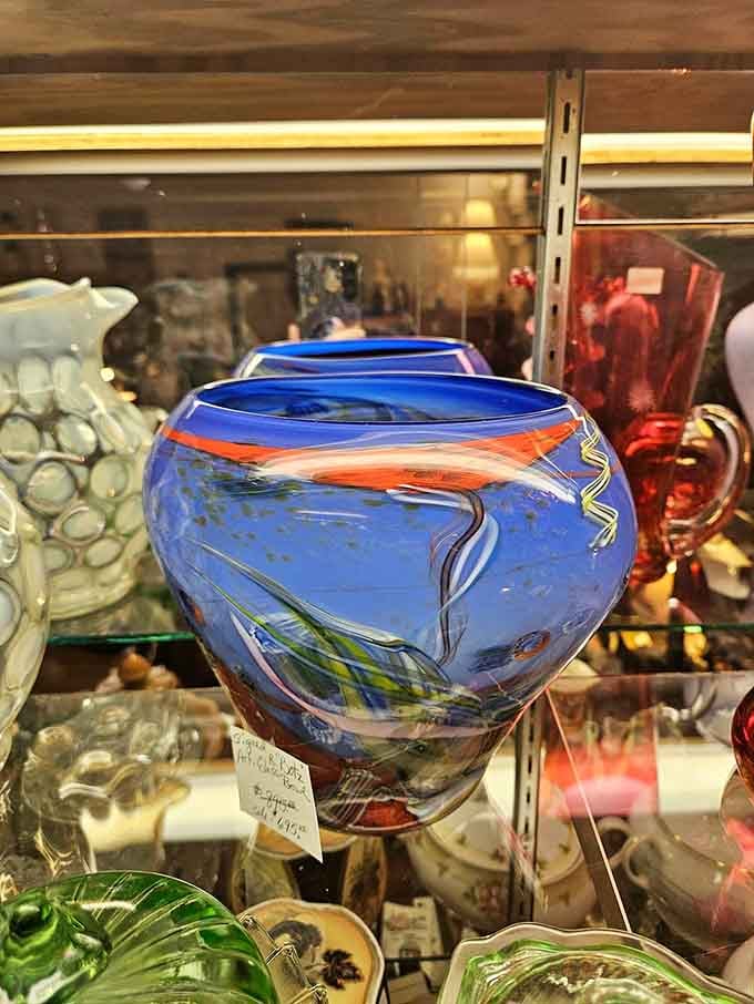 This blue art glass vase doesn't just hold flowers &ndash; it holds the vibrant colors of skilled craftspeople from decades past.