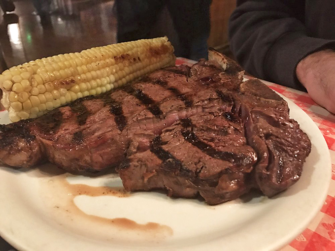 The bone-in ribeye steak sizzles with possibility &ndash; mesquite-grilled perfection that would make any trail boss tip his hat in approval.