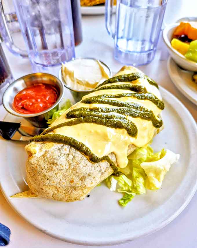 Breakfast burritos should all aspire to this level of greatness &ndash; stuffed to capacity, draped in melted cheese, and striped with green chile sauce like edible artwork.
