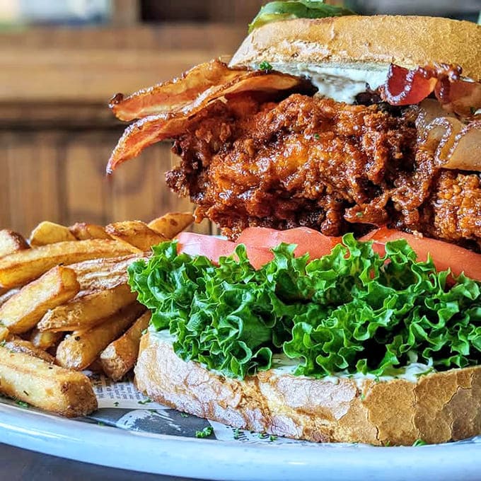 A sandwich that requires both hands and possibly a nap afterward – this towering creation comes with perfectly golden fries that'll disappear faster than you'd expect.