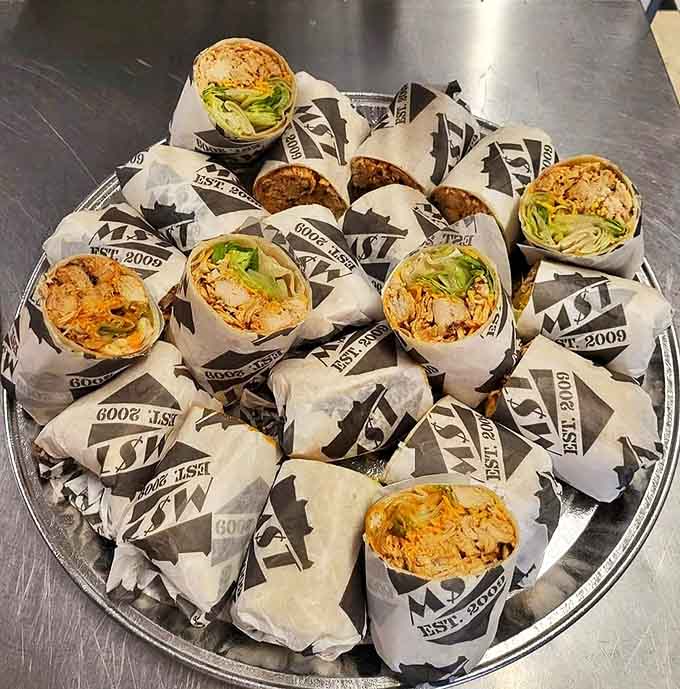 A platter of MST's legendary chicken wraps &ndash; each one a perfect handheld masterpiece of flavor and texture.