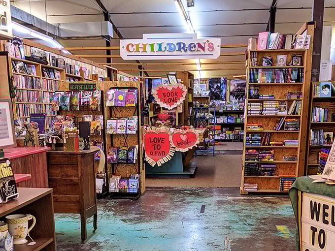 The children's section bursts with color and heart-shaped signs, creating a magical space where young imaginations can roam freely.