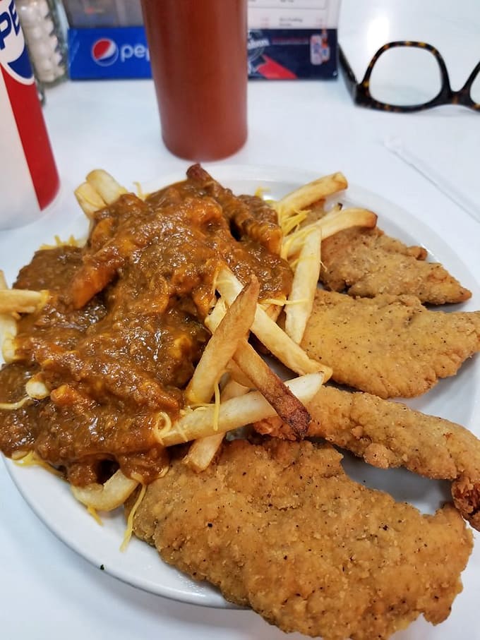 Comfort food perfection on a plate &ndash; golden chicken tenders and chili cheese fries that transform simple ingredients into a transcendent dining experience.