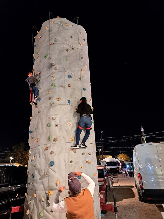 Reach for the sky! Young adventurers test their climbing skills on the portable rock wall, one of several family-friendly activities at the swap meet.