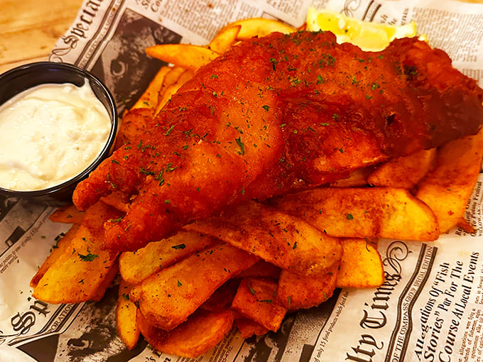 Golden-battered fish rests atop a mountain of perfectly crisp fries&mdash;comfort food elevated to an art form that would make any British pub proud.