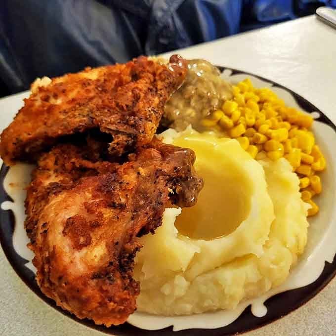 A perfect plate symphony: crispy chicken, buttery corn, and whipped potatoes with gravy. Comfort food doesn't get more photogenic than this.