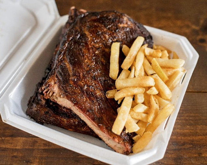 A full slab that's been kissed by smoke until it reaches pork perfection. The pink smoke ring is nature's way of saying "you're welcome."