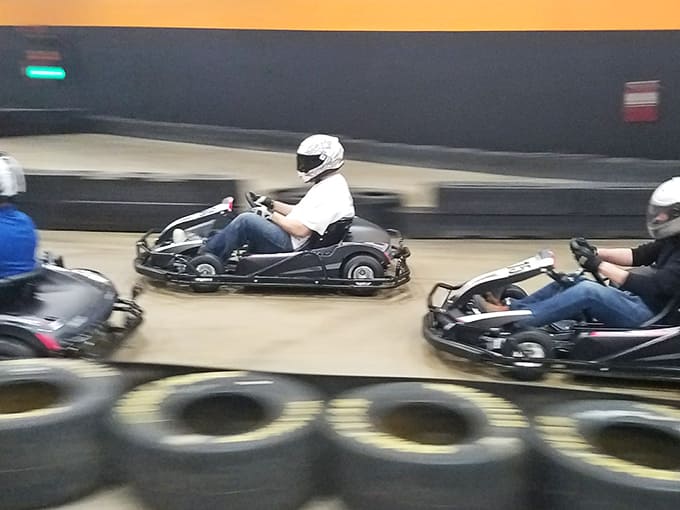The electric hum of karts racing around the track creates an atmosphere of pure adrenaline and friendly competition.