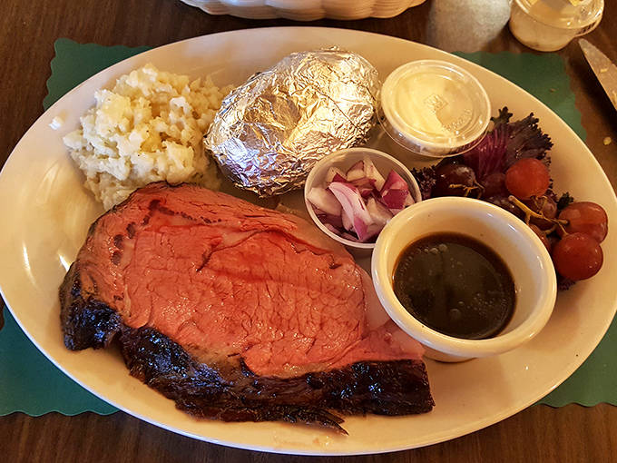 Medium-rare perfection on a plate. The prime rib's rosy interior reveals the kitchen's mastery of timing and temperature.