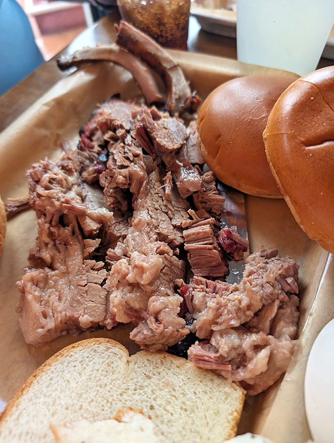 Beef brisket so tender it practically surrenders at the sight of your fork, served with a side of bread for sopping duties.