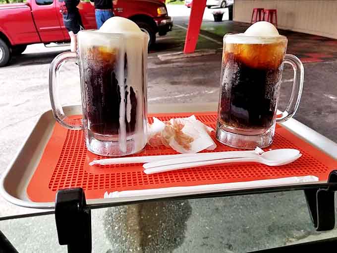Twin root beer floats await their fate &ndash; that magical moment when ice cream and root beer create a frothy symphony of sweetness.