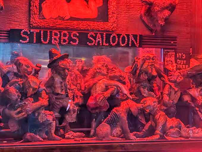 A diorama depicting saloon life sits beneath the red glow &ndash; one of countless miniature scenes tucked among larger artifacts throughout the establishment.