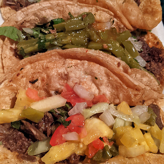 A symphony of flavors: Perfectly charred tortillas embrace seasoned meats, while roasted jalapeños add a smoky kick to the ensemble.