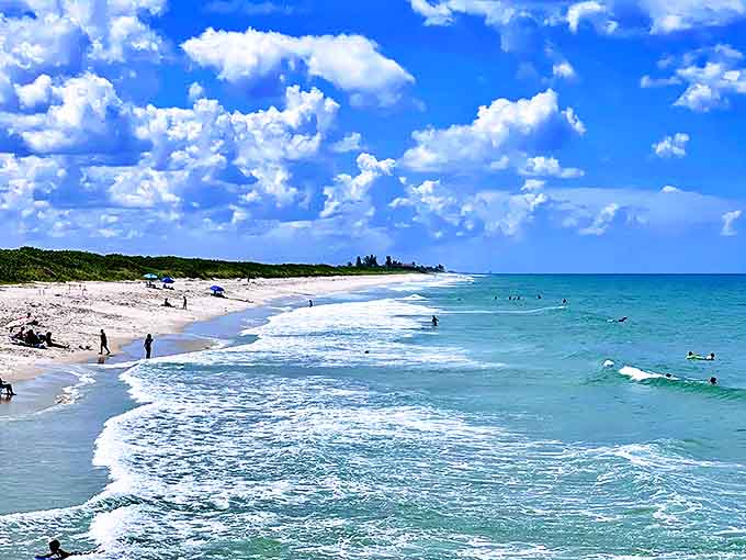 Sun-seekers enjoy the pristine beach, where the rhythm of waves provides nature's perfect soundtrack for relaxation.