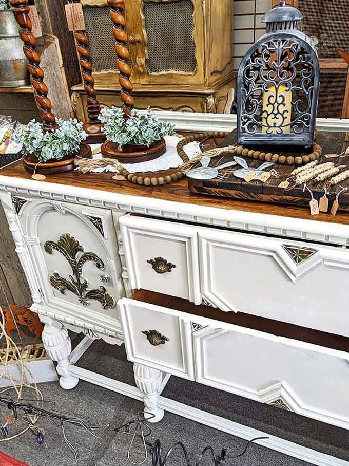 This white buffet whispers tales of Sunday dinners and holiday gatherings, its shabby chic makeover breathing new life into solid craftsmanship.
