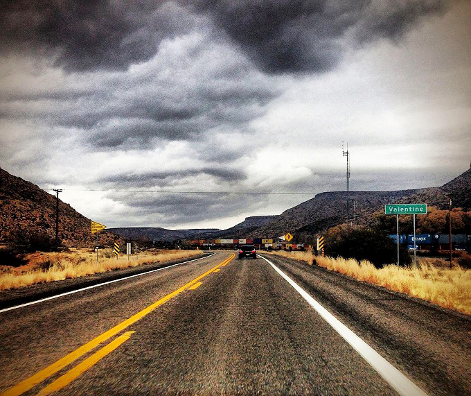 Road trip nostalgia meets geological wonder on this stretch of Route 66. The dinosaur is just bonus entertainment!